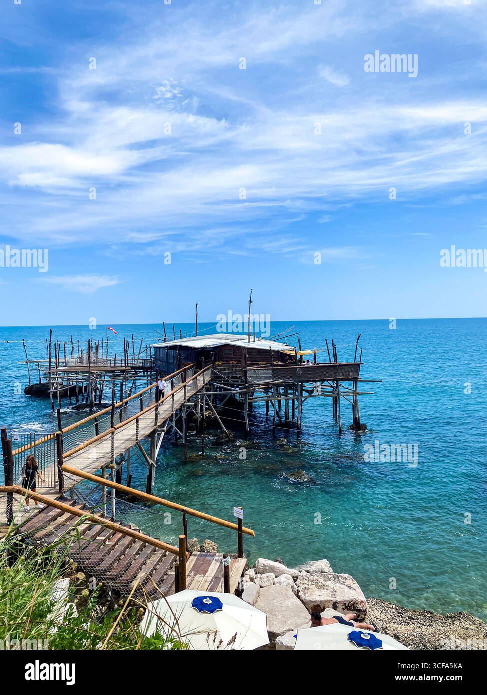 Weathered wooden pier extending over adriatic seascape, traditional ...