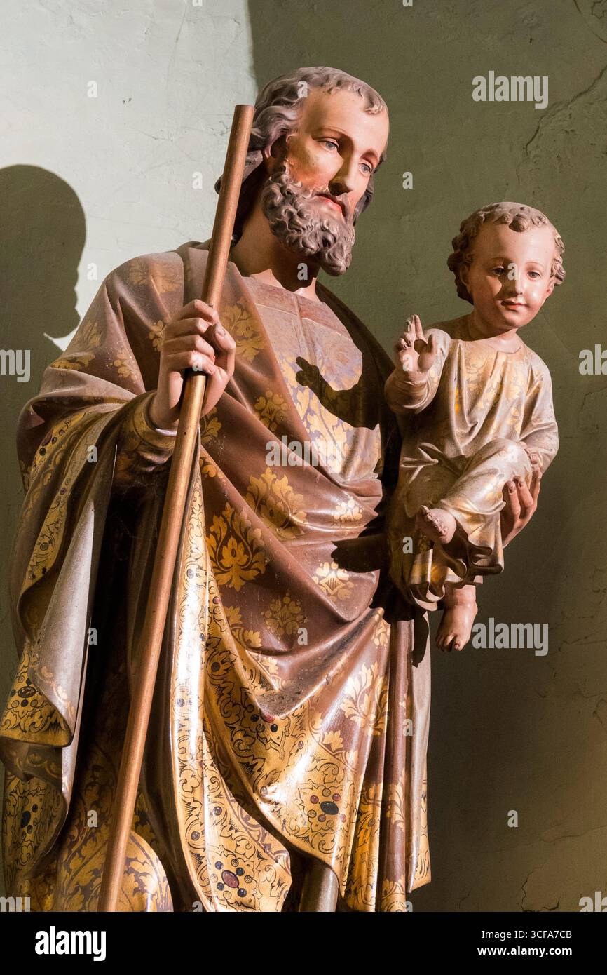 Statue (19th century) of Saint Joseph holding baby Jesus Christ in his ...