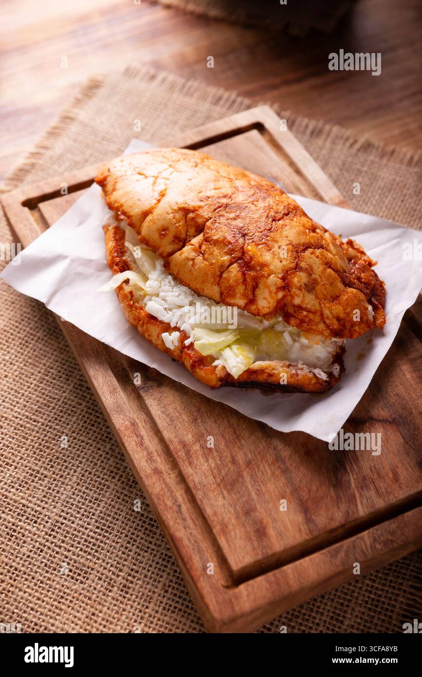 Pambazo. Sandwich marinated in guajillo chili sauce and roasted on a ...
