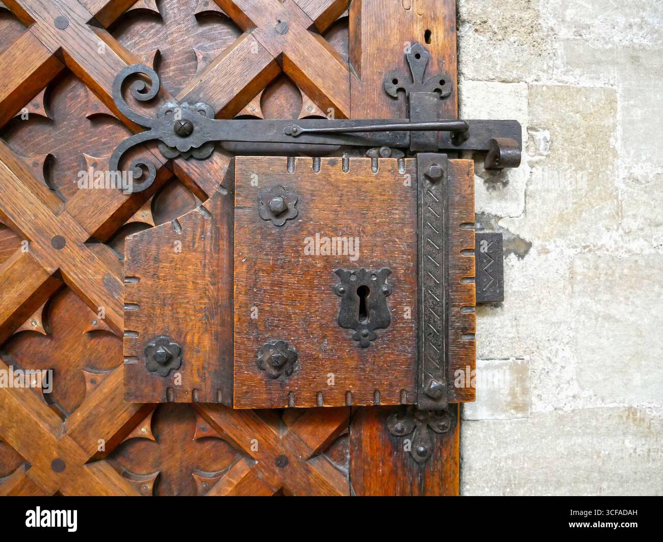 Medieval oak door with intricate iron lock, fleur-de-lis and quatrefoil ...