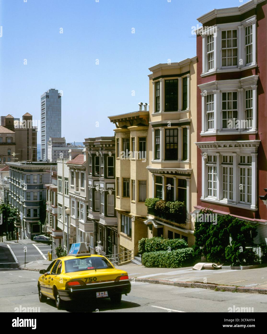 A yellow taxi cab going down Mason Street from Hob Hill past Victorian ...
