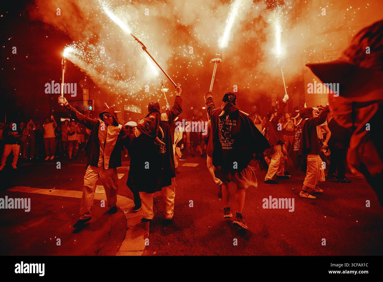 Barcelona, Spain. 21 August, 2025: Fire runners in devil costumes ...