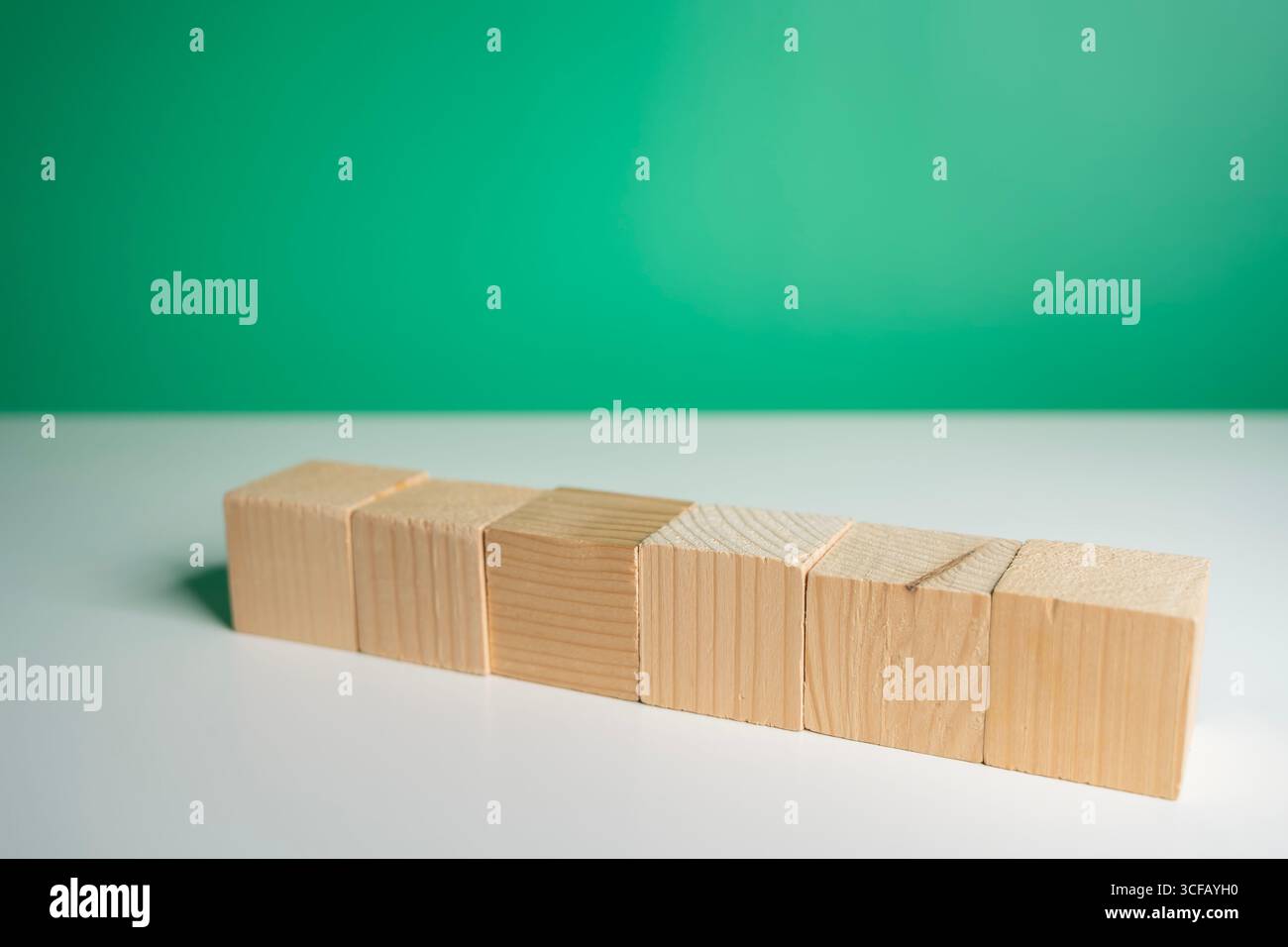 Minimalist composition of natural wooden cubes placed in a row on a ...