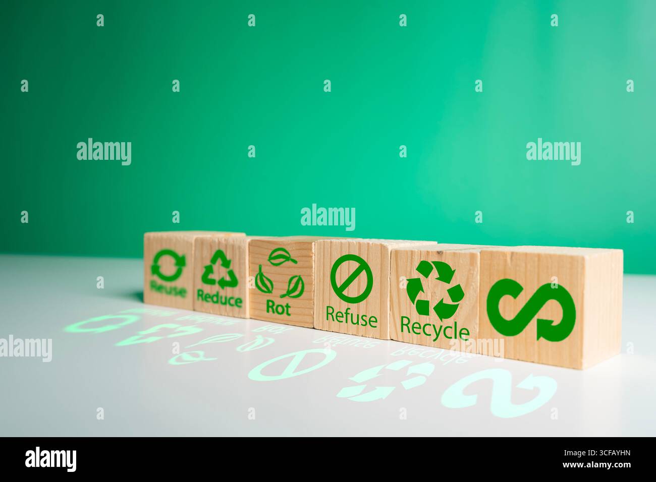 Eco-friendly wooden blocks with green symbols representing reuse ...