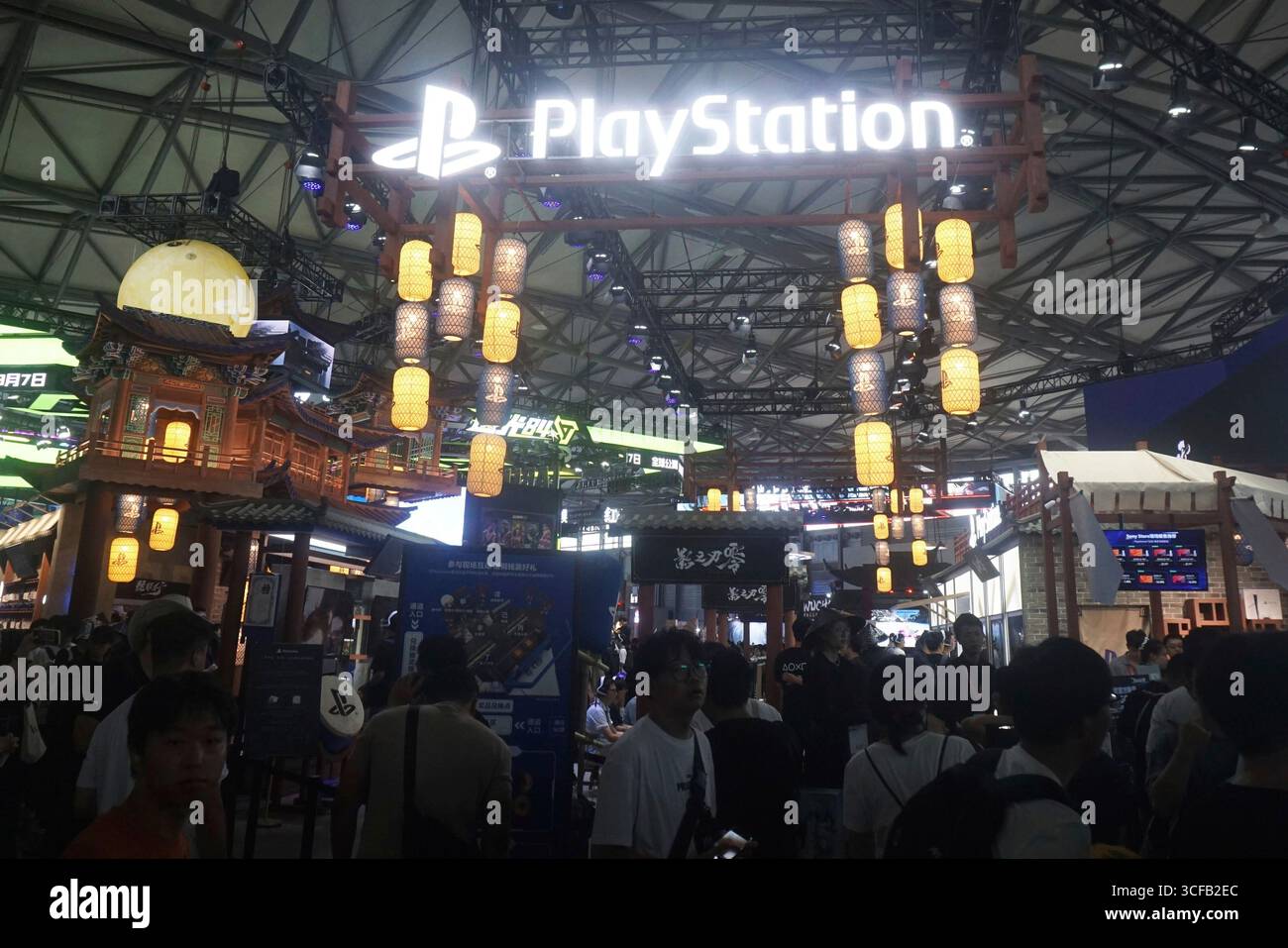 People visit the booth of Sony's PlayStation in a digital entertainment ...