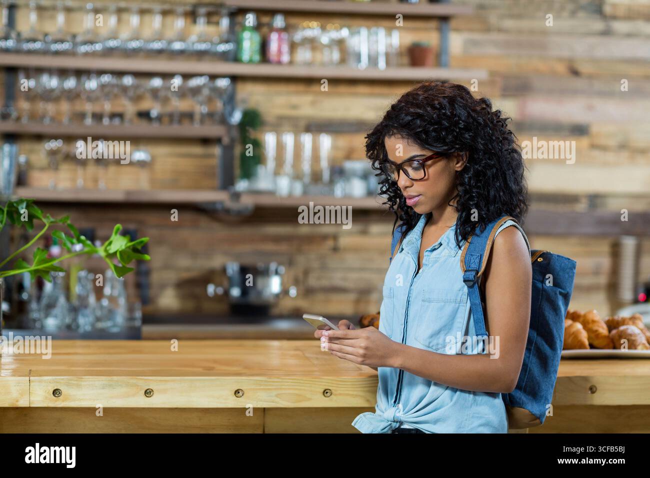 Woman standing café wooden hi-res stock photography and images - Alamy