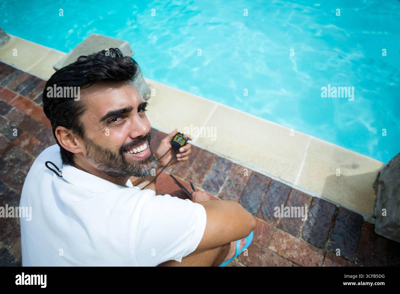 Male swimming coach crouching hi-res stock photography and images - Alamy