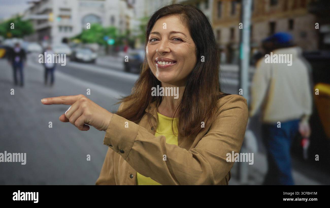Woman pointing finger at traffic on a busy city street while winking ...
