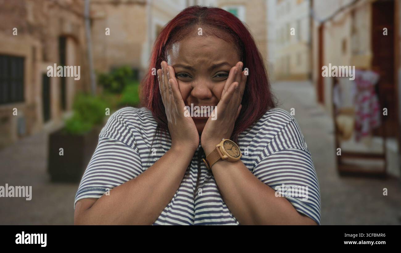 Woman crossing arms over chest with clenched posture and distressed ...