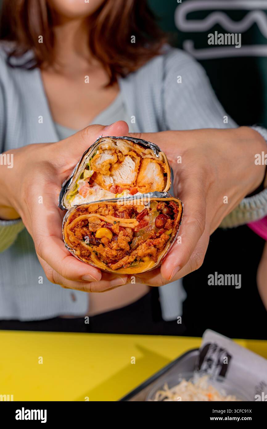 Girl holding shawarma in hi-res stock photography and images - Alamy