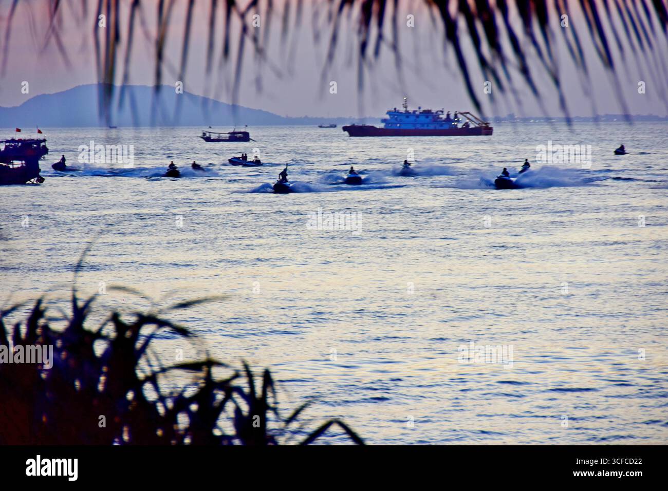 Tourists play at the seaside in Sanya City, southernmost China's Hainan ...