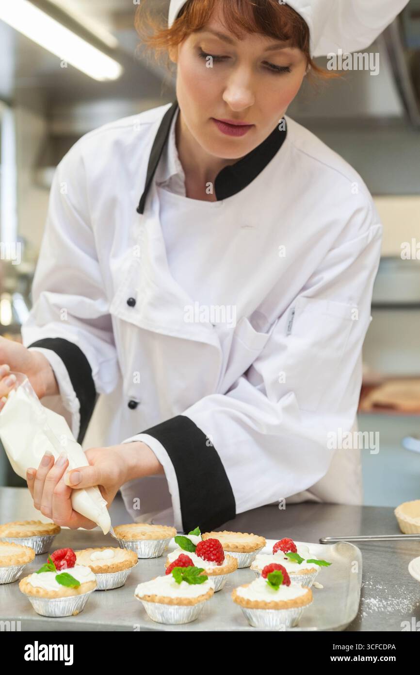 Female pastry chef using piping hi-res stock photography and images - Alamy
