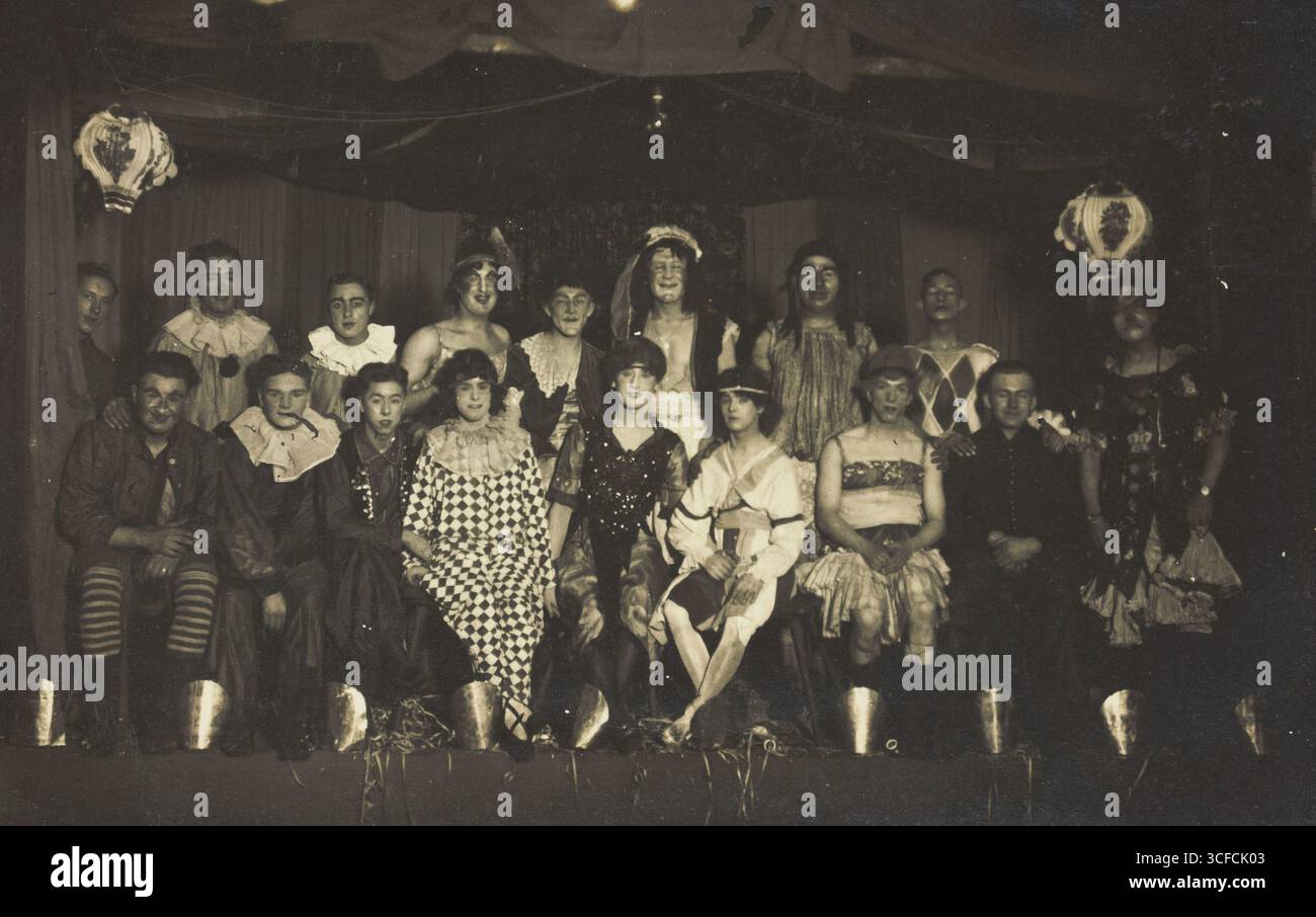 An ensemble cast of British soldiers, some in drag, pose on stage, 1919 ...