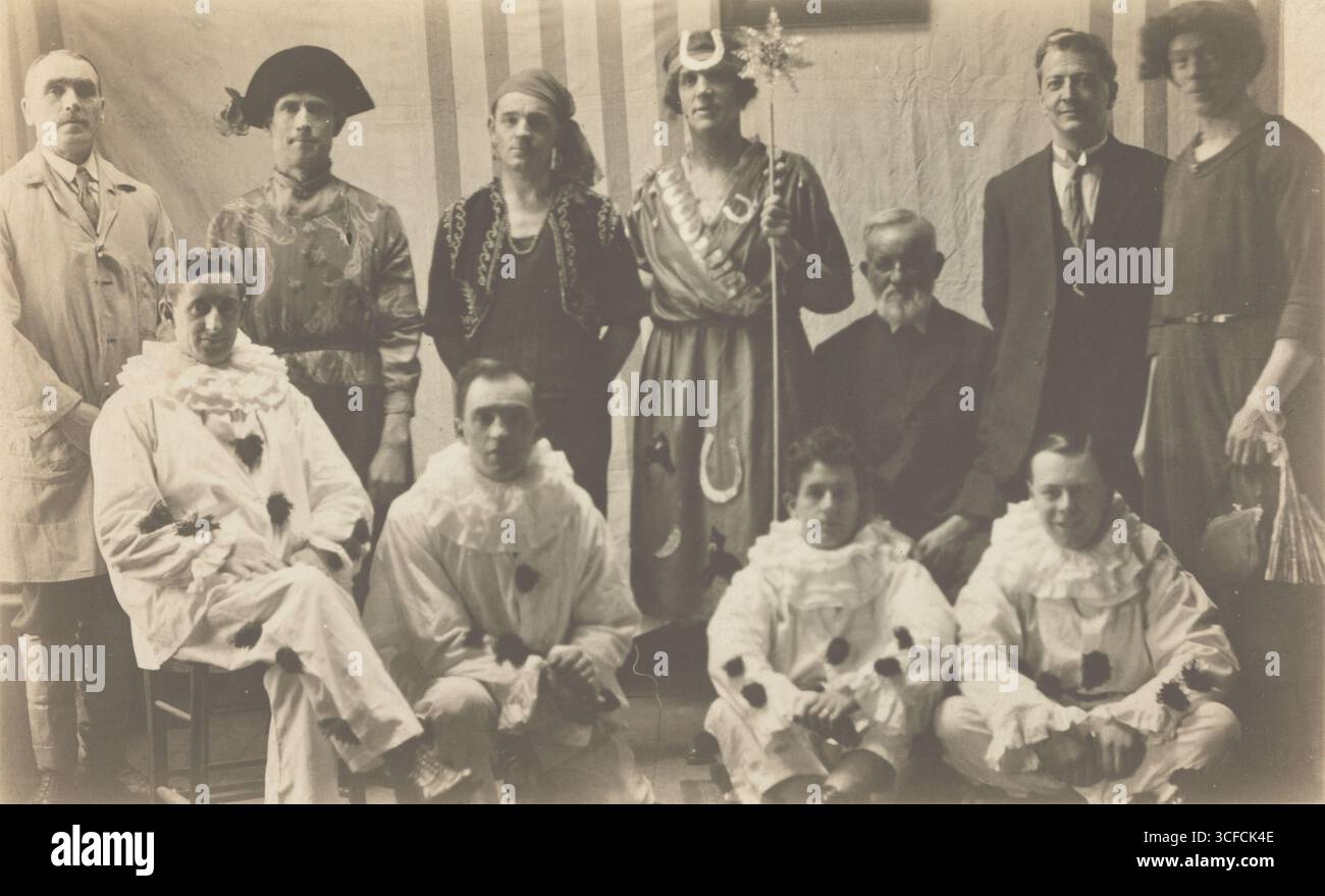 Concert party performers, some in drag, pose for a group portrait ...