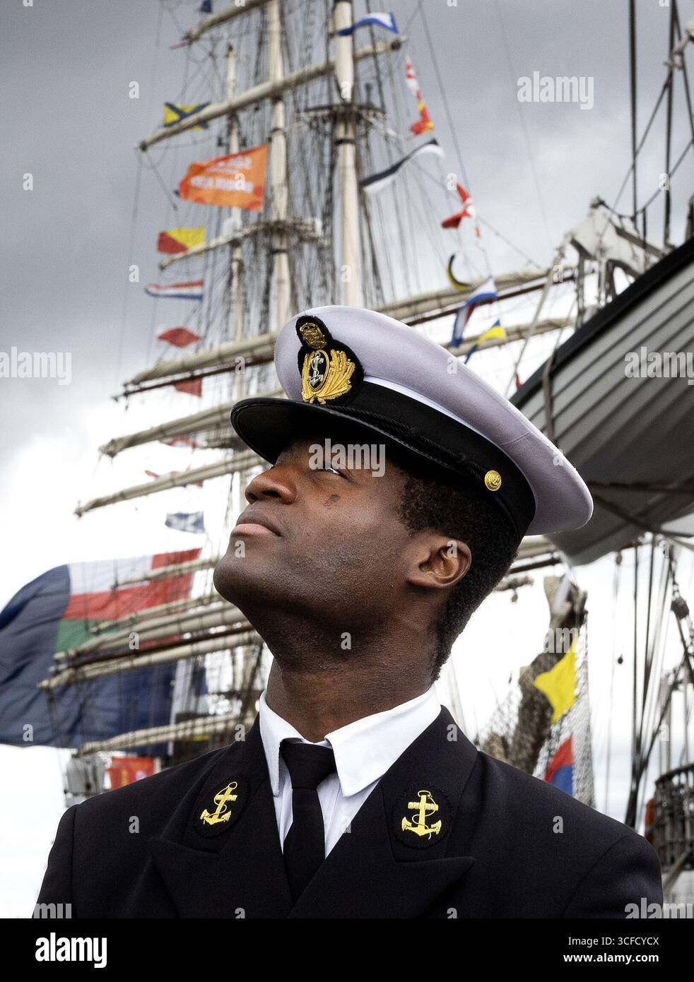 AMSTERDAM – A sailor in front of a ship at the IJ harbor during the ...