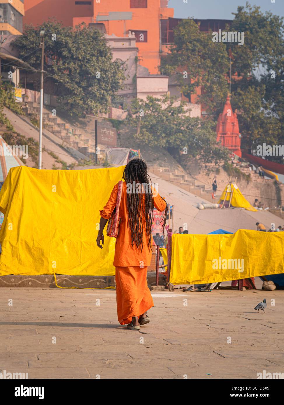 Orange-Robed Sadhu with Long Dreadlocks Walks Past Bright Yellow ...