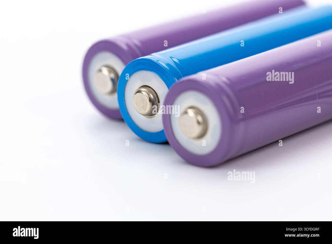 A purple and blue rechargeable batteries on white background close up ...