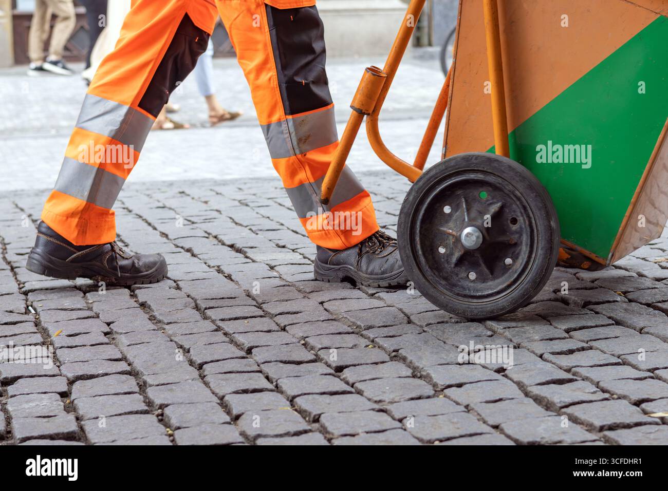 Worker rolling garbage bin hi-res stock photography and images - Alamy