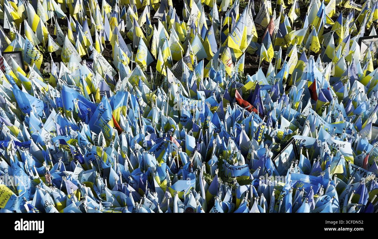 Many small blue-yellow flags with names of the dead war against russia ...