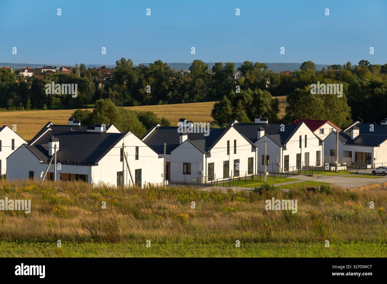 View of newly built modern suburban houses in a quiet residential area ...