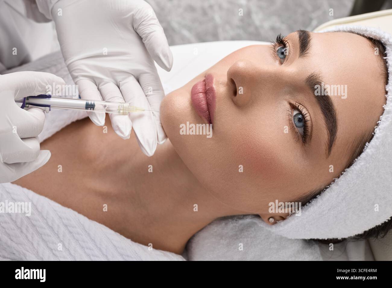 Syringe near woman's chin, beauty injections with fillers for chin ...