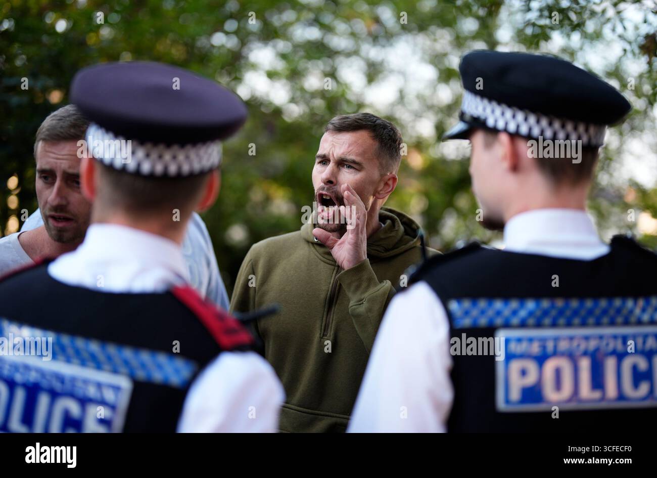 Police officers with counter protesters as people take part in the ...