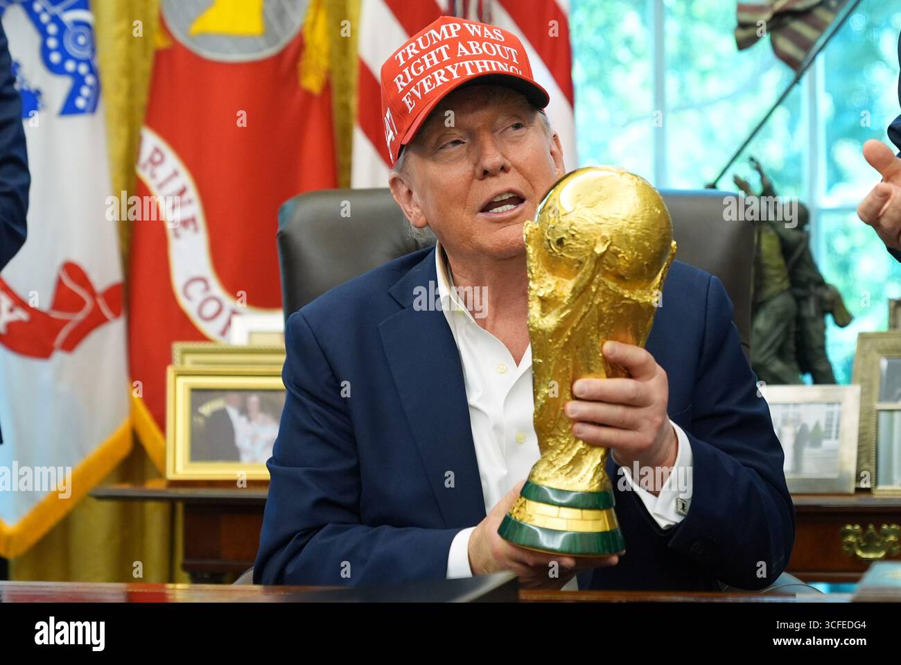 President Donald Trump holds the FIFA World Cup Winners Trophy as he ...