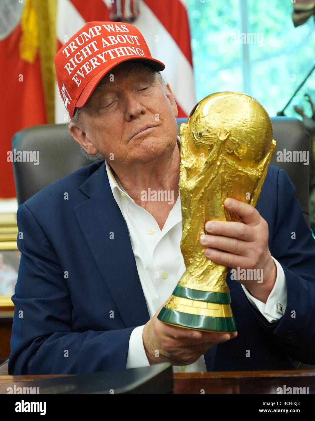 President Donald Trump holds the FIFA World Cup Winners Trophy during ...