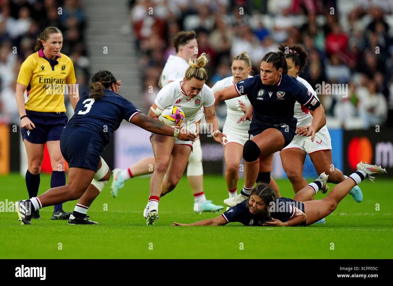 England's Megan Jones (centre) is tackled by USA's Keia Mae Sagapolu ...