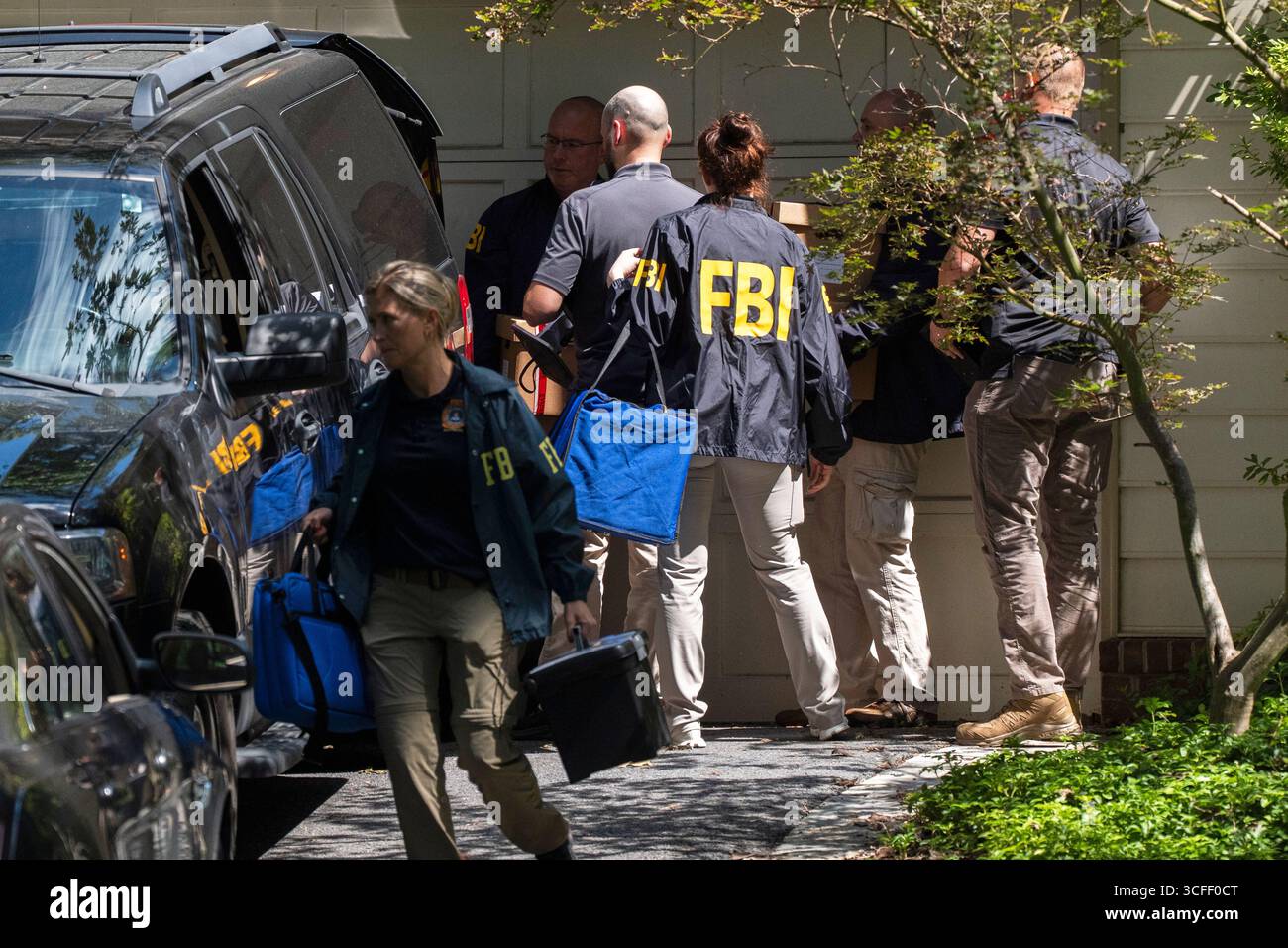 FBI agents carry bags and boxes out of former national security adviser ...