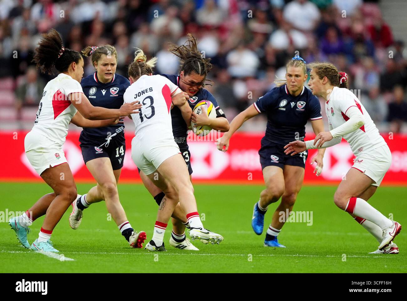 USA's Ilona Maher (centre right) is tackled by England's Megan Jones ...