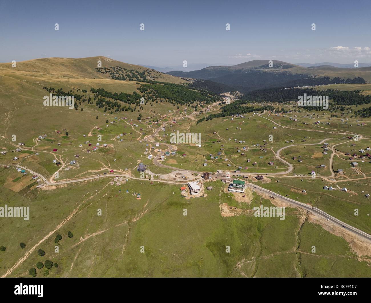 Aerial view of a high-altitude village nestled among rolling hills ...