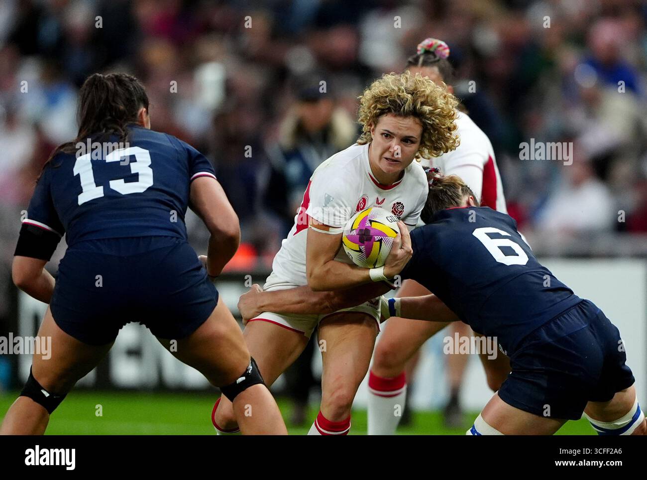 England's Ellie Kildunne (centre) is tackled by USA's Ilona Maher (left ...