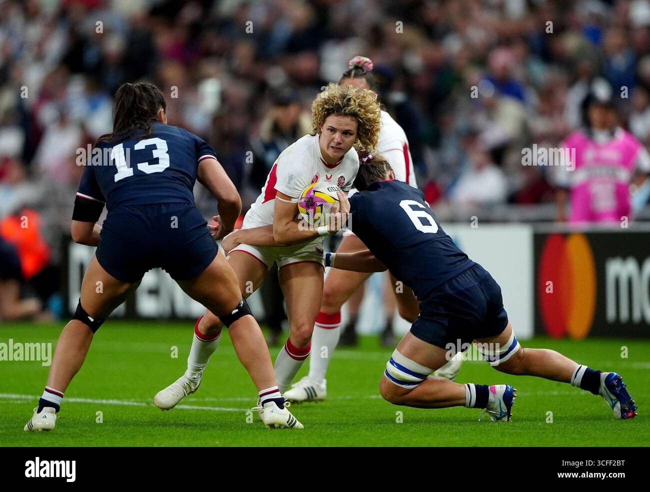 England's Ellie Kildunne (centre) is tackled by USA's Ilona Maher (left ...