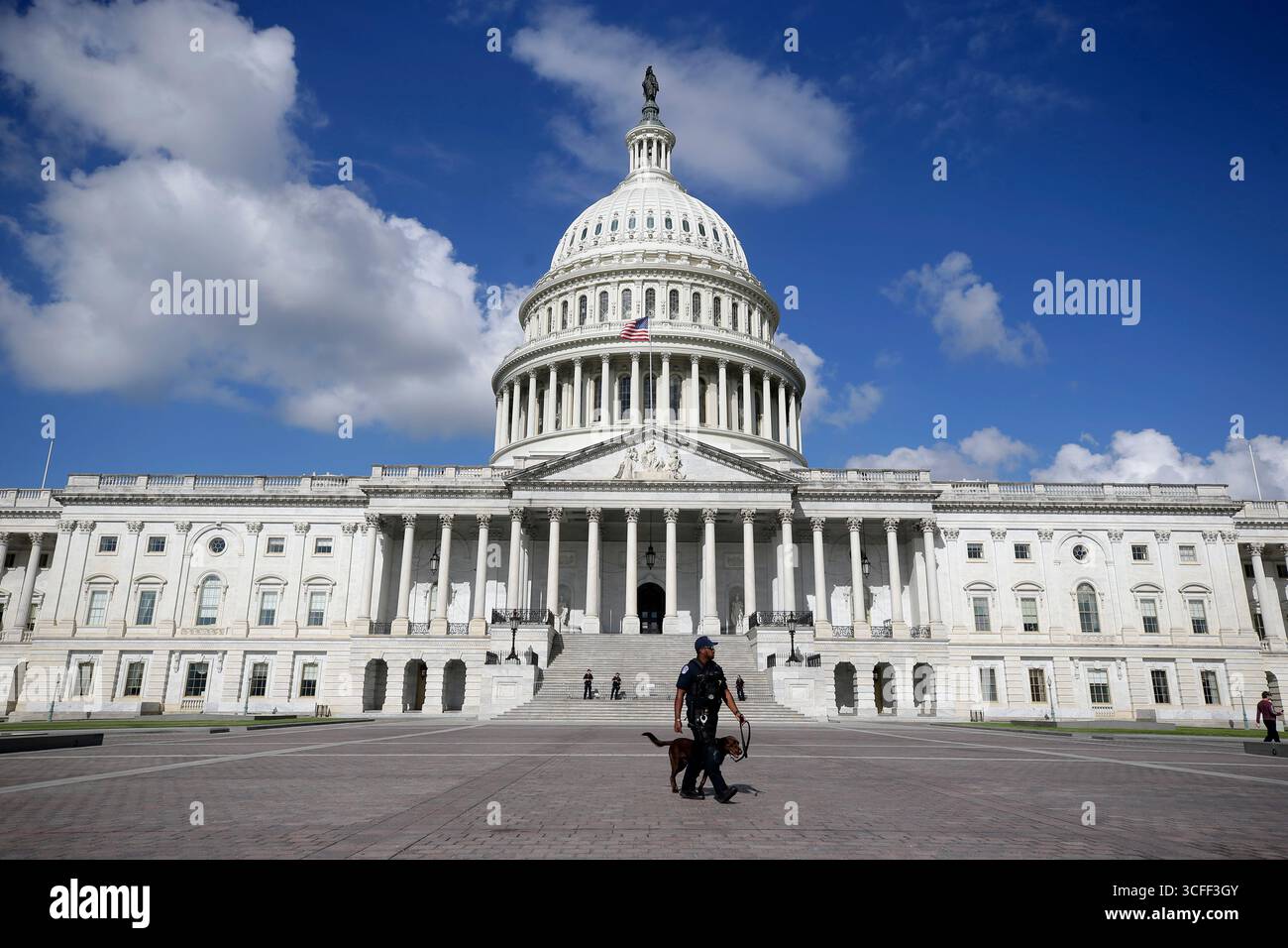 A U.S. Capitol Police officer walks in front of the U.S. Capitol ...