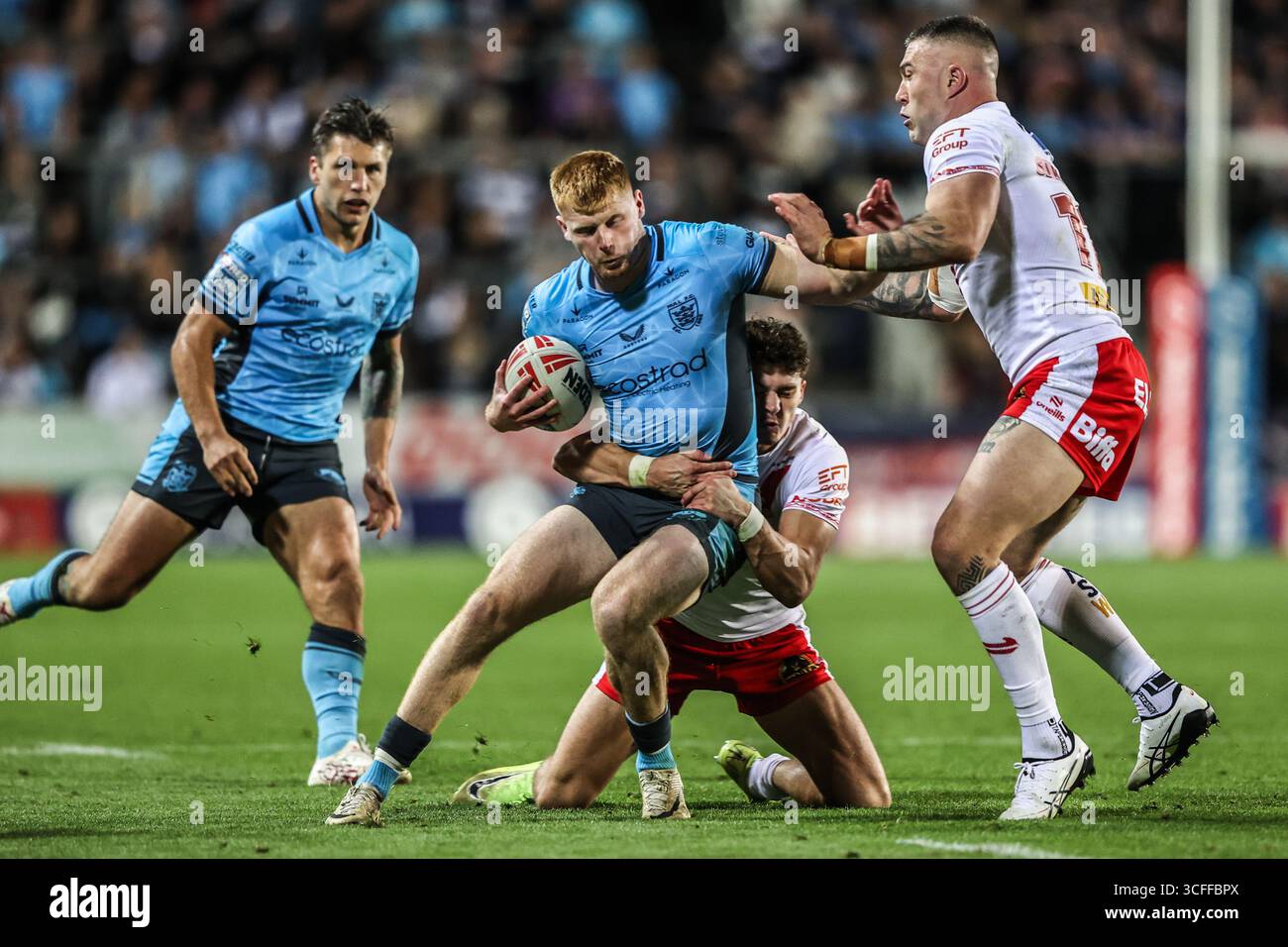 Harvey Barron of Hull FC is tackled during the Betfred Super League ...