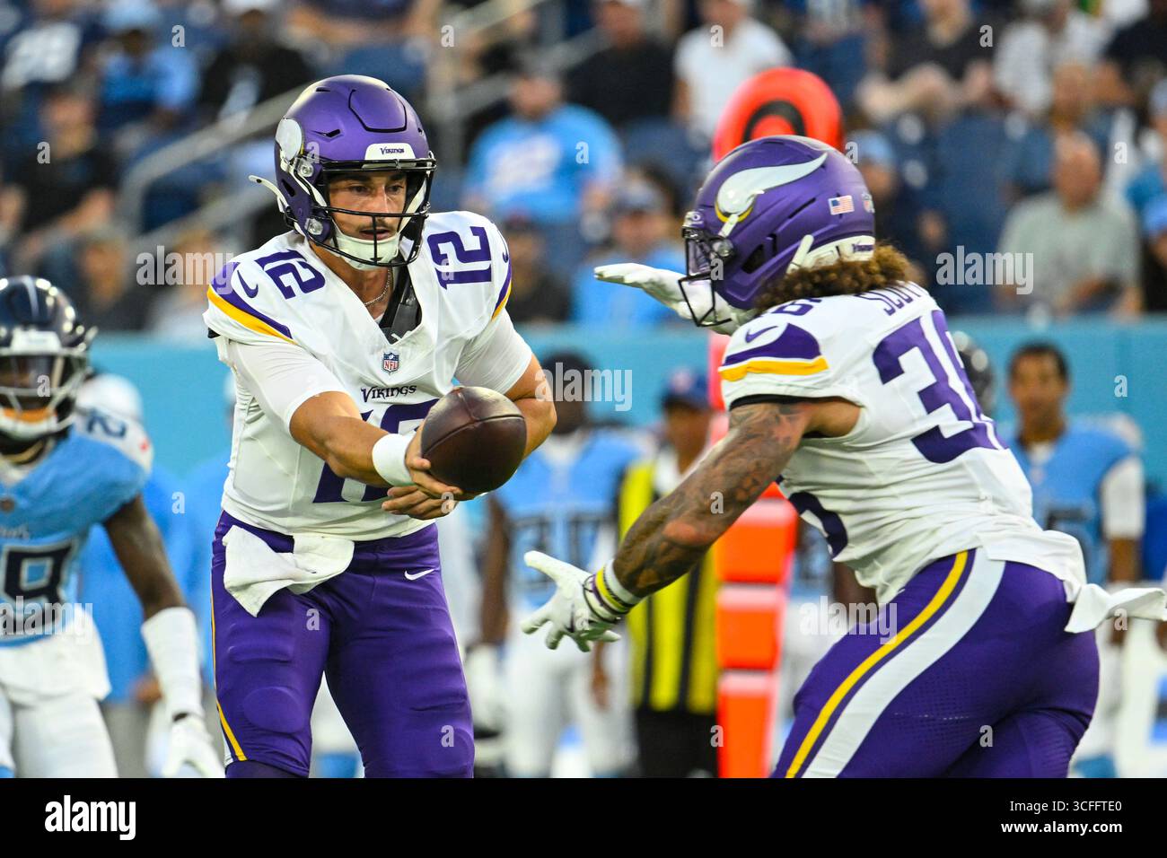 Minnesota Vikings quarterback Max Brosmer (12) hands off to running back Zavier Scott (36 ...