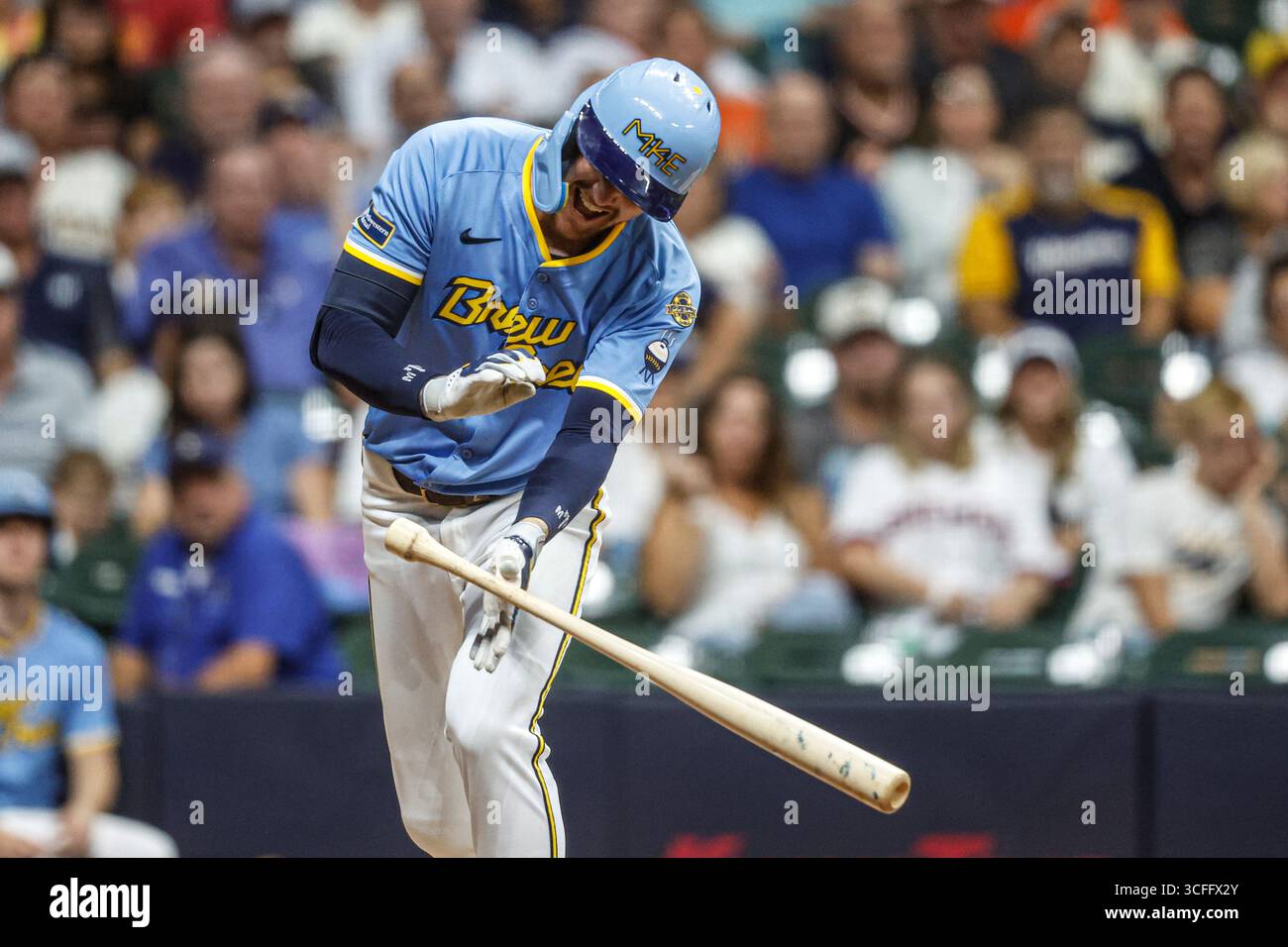 Milwaukee Brewers' Brice Turang reacts after getting hit with a pitch ...