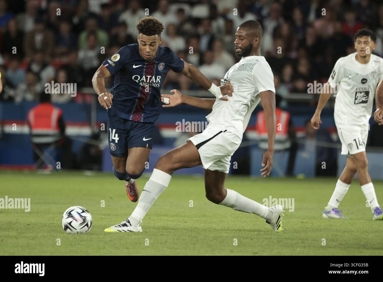 Desire Doue of PSG, Ousmane Camara of Angers during the French ...