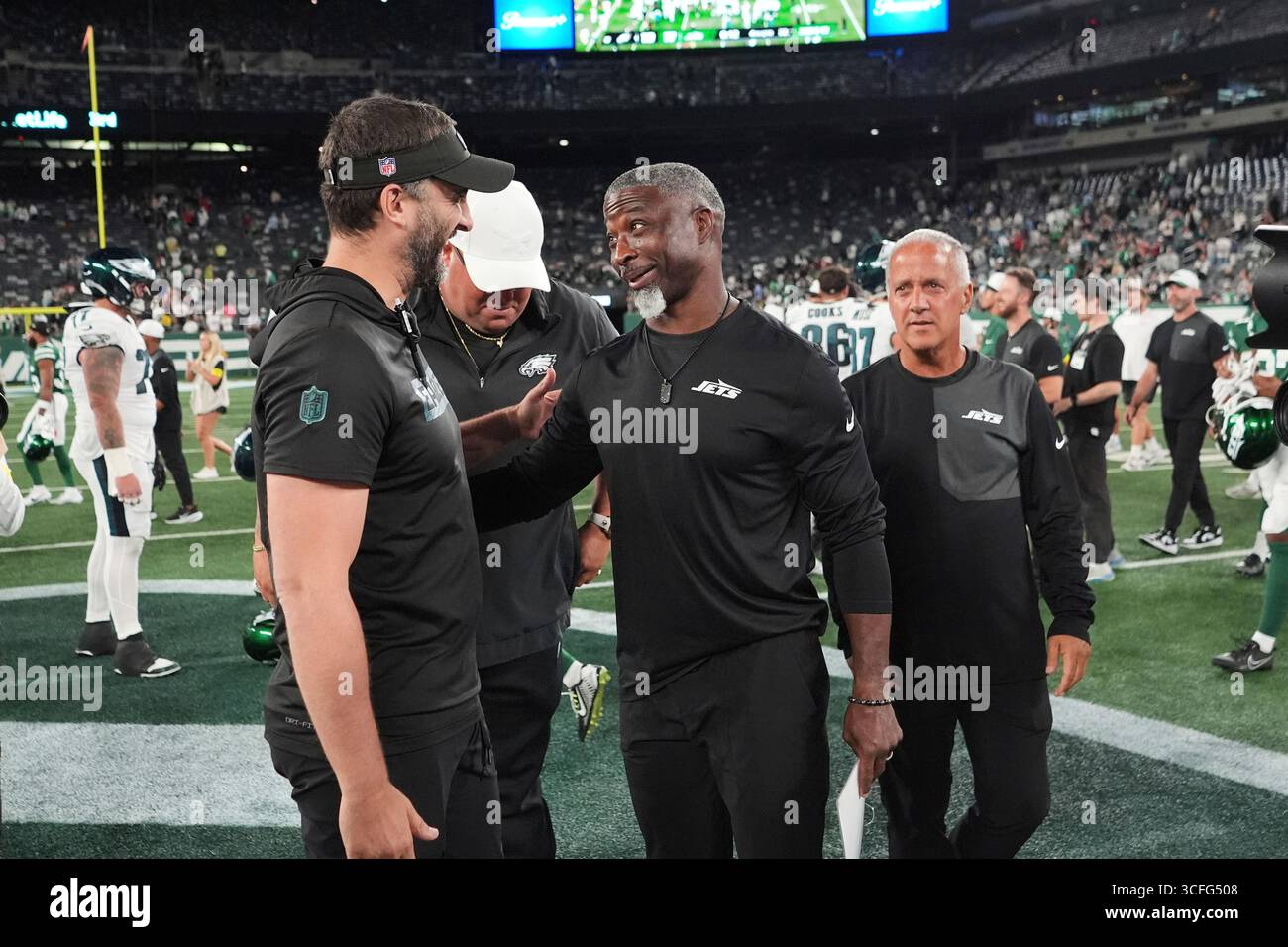 New York Jets head coach Aaron Glenn, right, greets Philadelphia Eagles ...