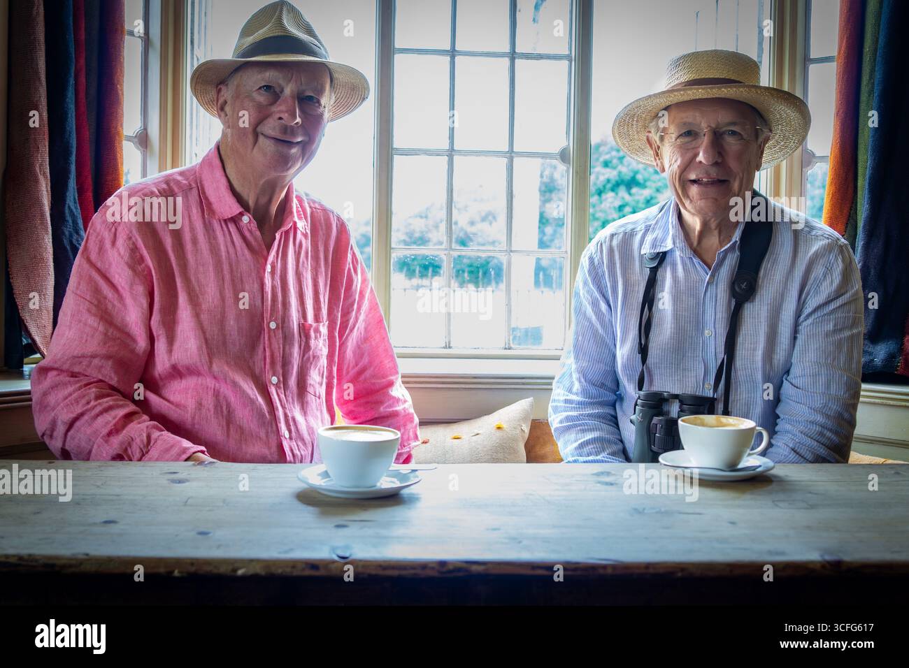 Norfolk United Kingdom - July 13 2025; Two English gentlemen seated and ...