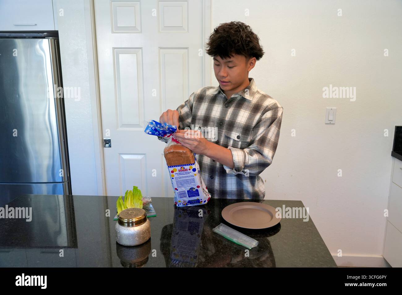 Braxton Kimura prepares food at home on Wednesday, Aug. 13, 2025, in ...