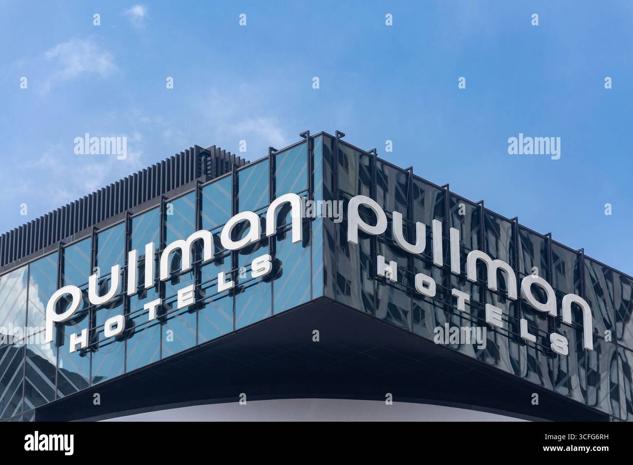 Upscale Pullman hotels, signage on top against the blue sky, holiday ...