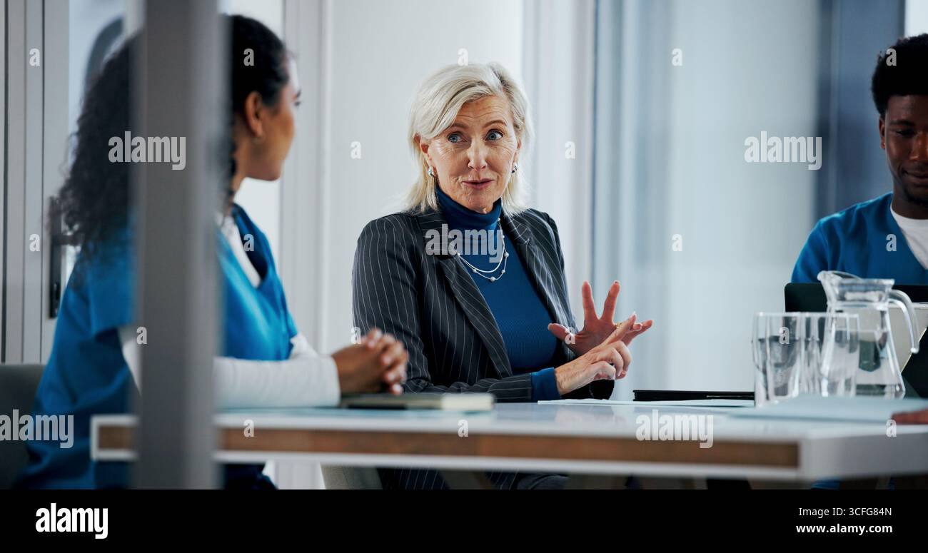 Doctors, discussion and business woman in meeting for hospital manager ...