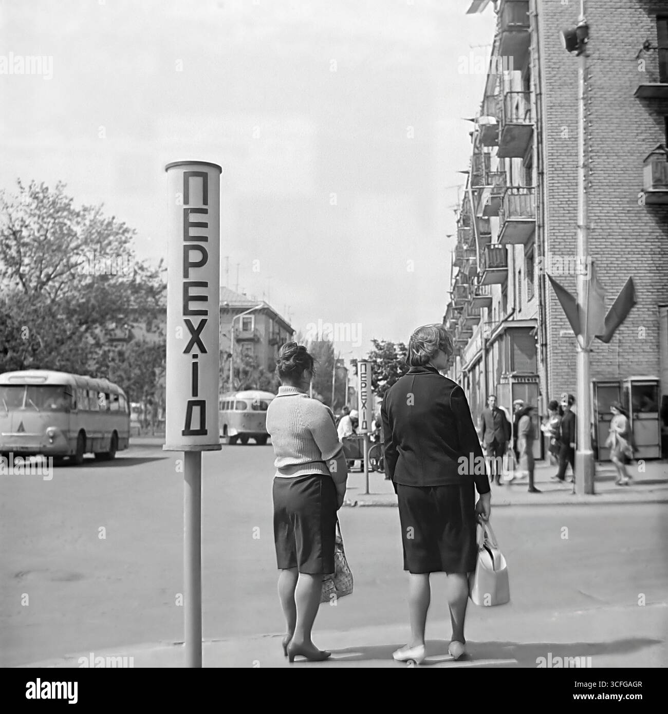Two women at a pedestrian crossing on Lenina Street (now Universytetska ...
