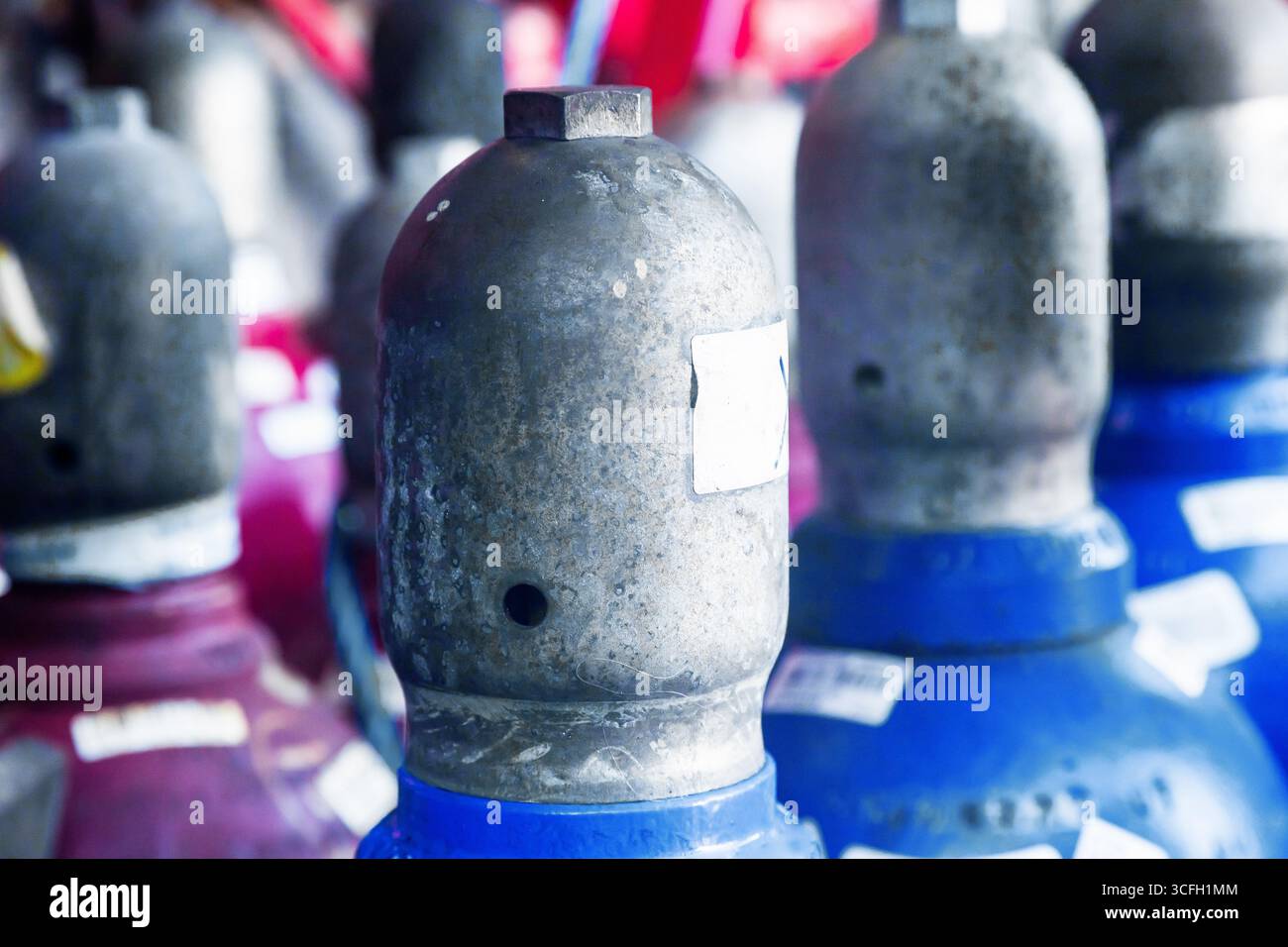 The upper part of gas cylinders with oxygen and acetylene with caps put ...