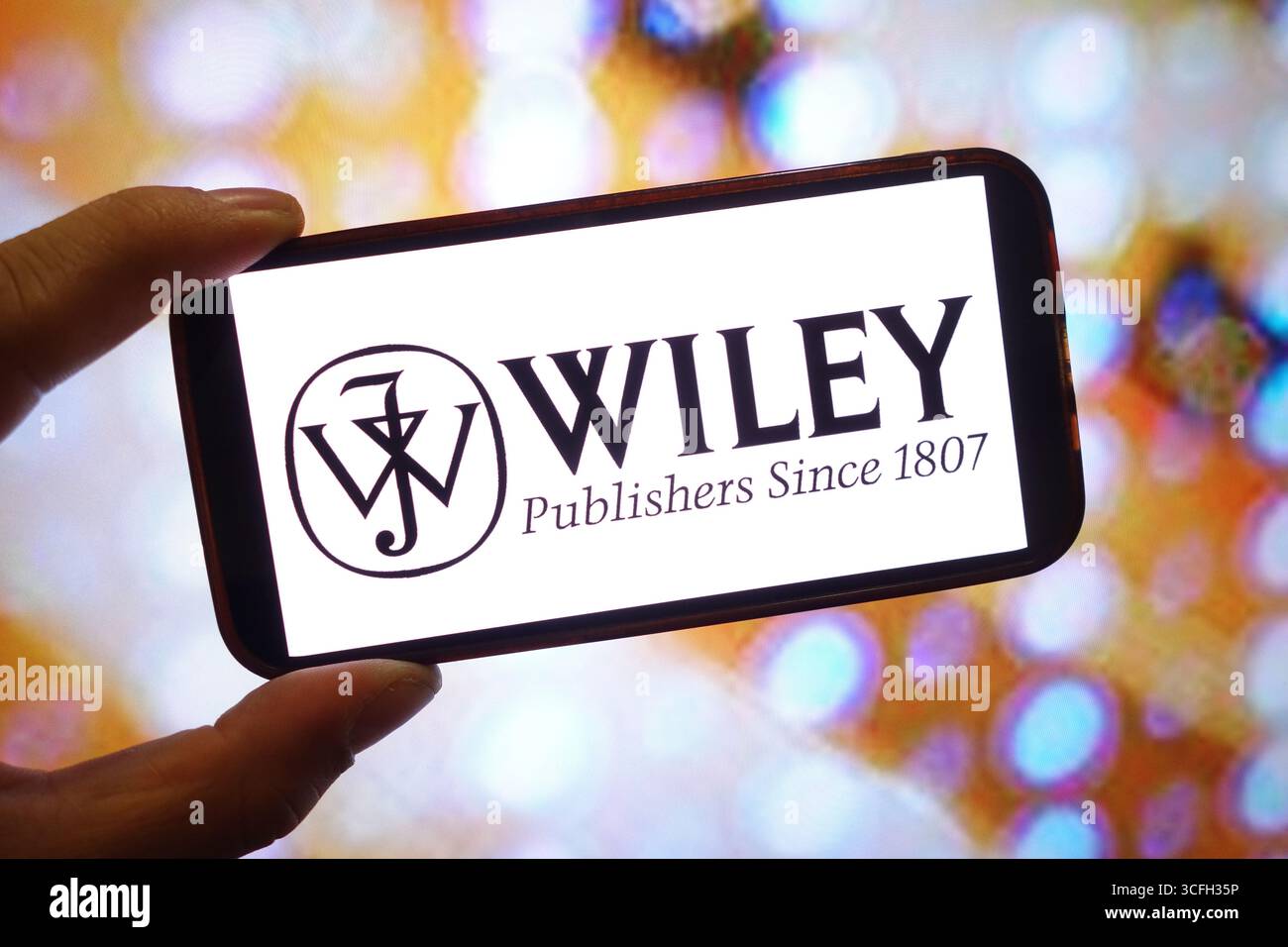 In this photo illustration, a John Wiley and Sons company logo is seen ...