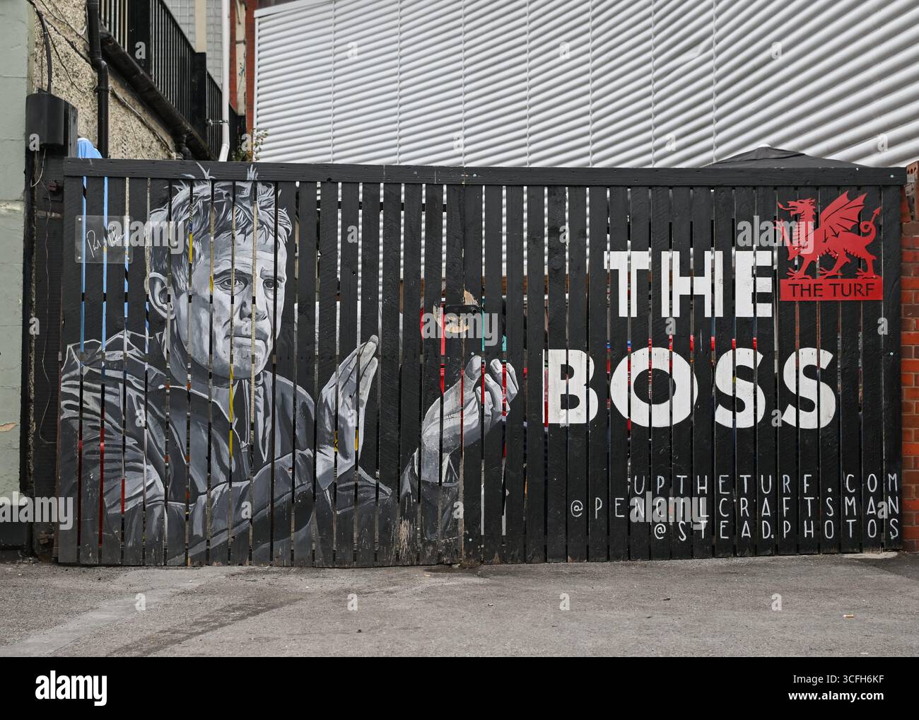 A mural of Wrexham manager Phil Parkinson near the SToK Cae Ras ahead ...