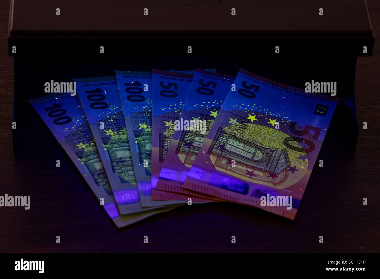 100 euro bills under ultraviolet hi-res stock photography and images ...