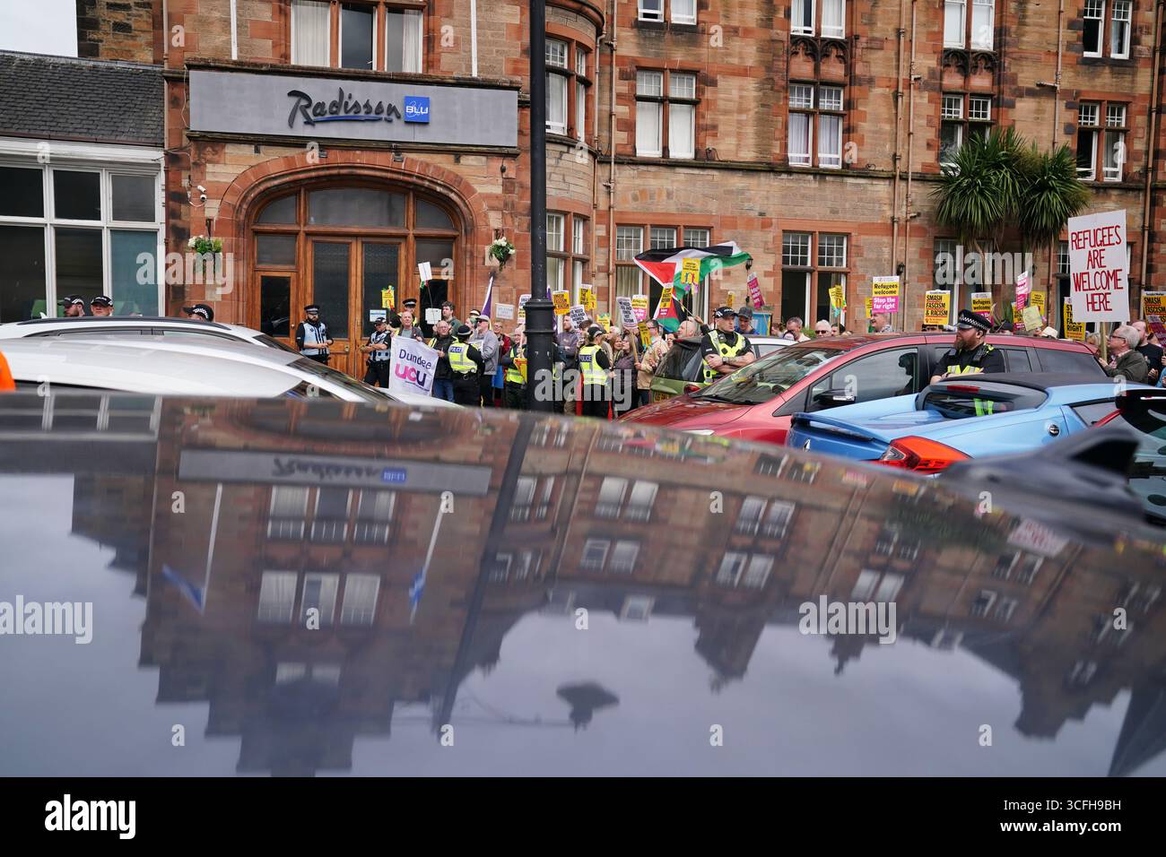 People take part in a counter protest against an Abolish Asylum System ...